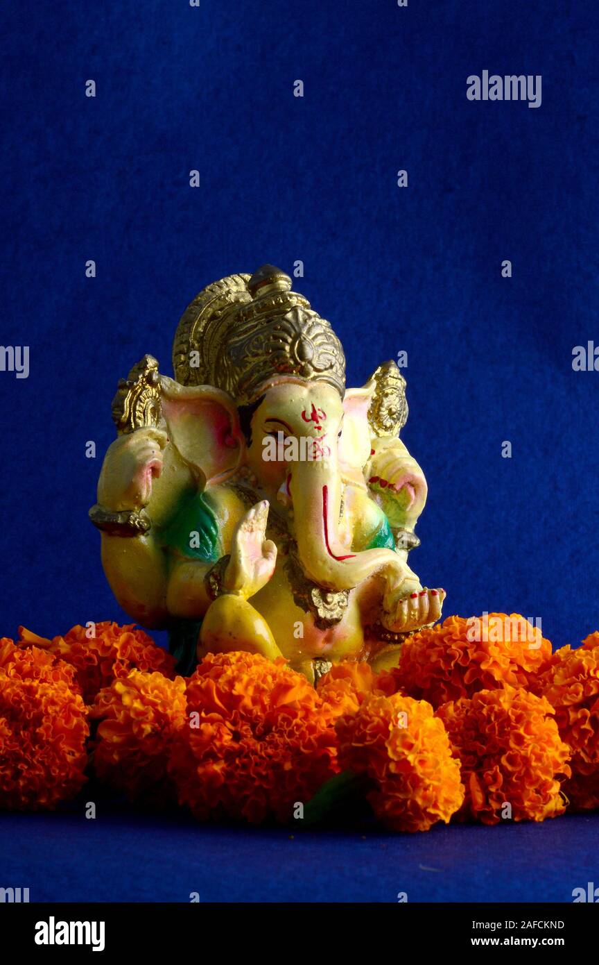 Hindu God Ganesha. Ganesha Idol on Blue Background Stock Photo - Alamy