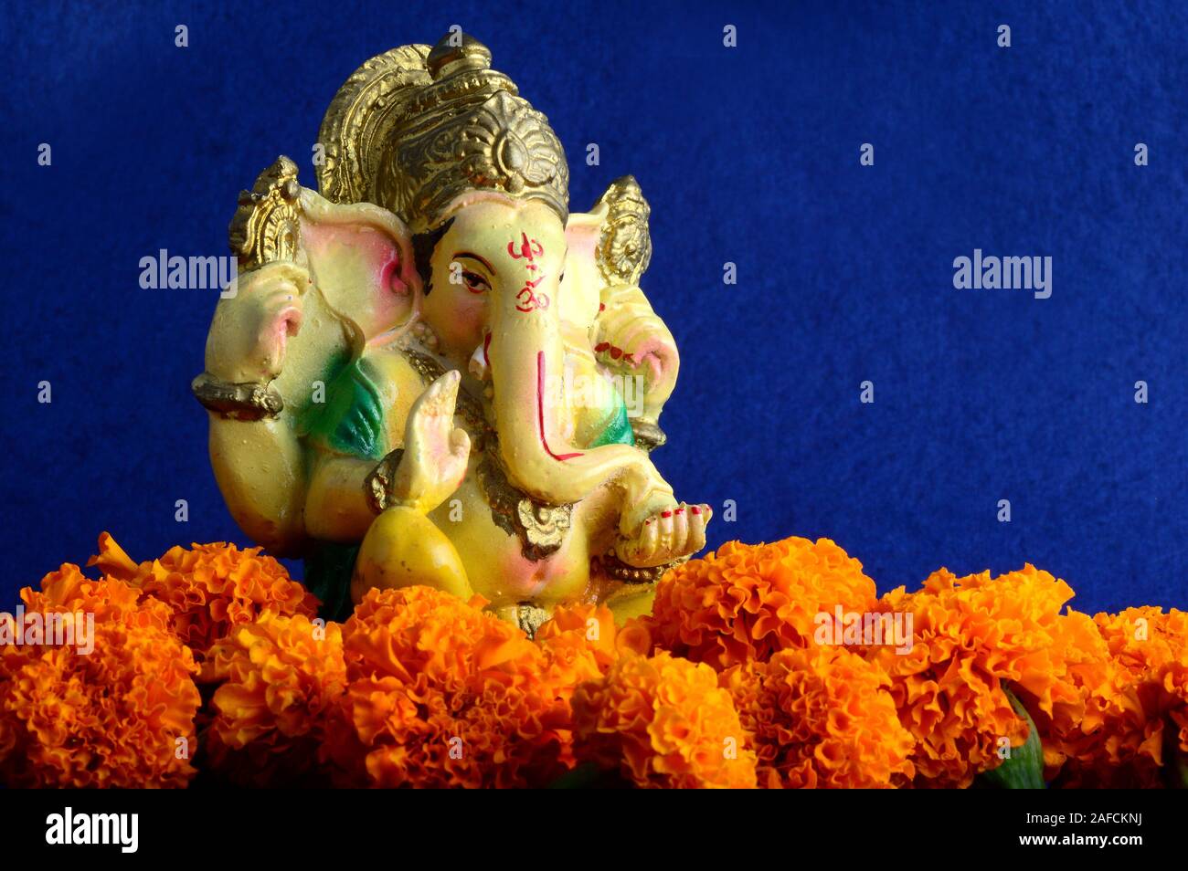 Hindu God Ganesha. Ganesha Idol on Blue Background Stock Photo - Alamy