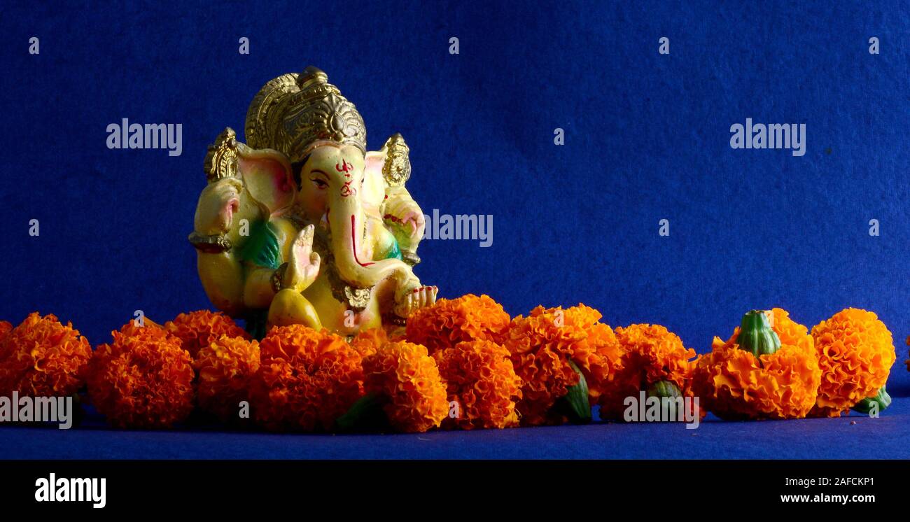 Hindu God Ganesha. Ganesha Idol on Blue Background Stock Photo - Alamy