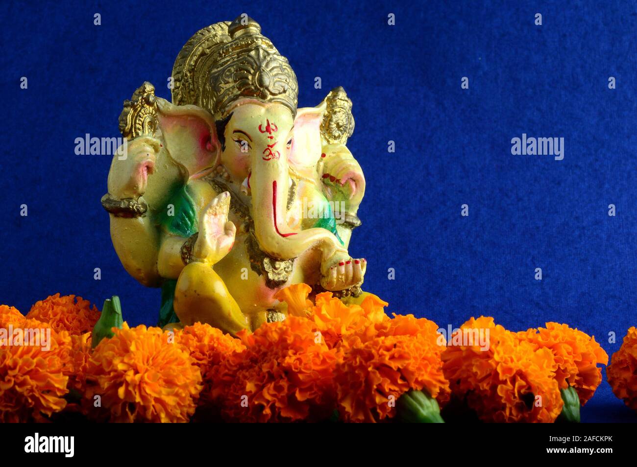 Hindu God Ganesha. Ganesha Idol on Blue Background Stock Photo - Alamy