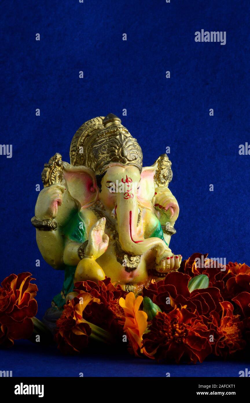 Hindu God Ganesha. Ganesha Idol on Blue Background Stock Photo - Alamy