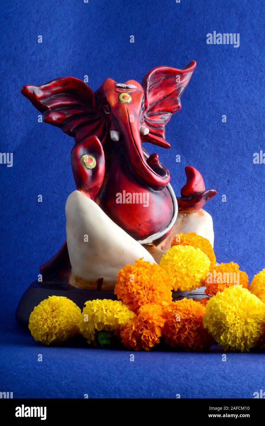 Hindu God Ganesha. Ganesha Idol on Blue Background Stock Photo - Alamy