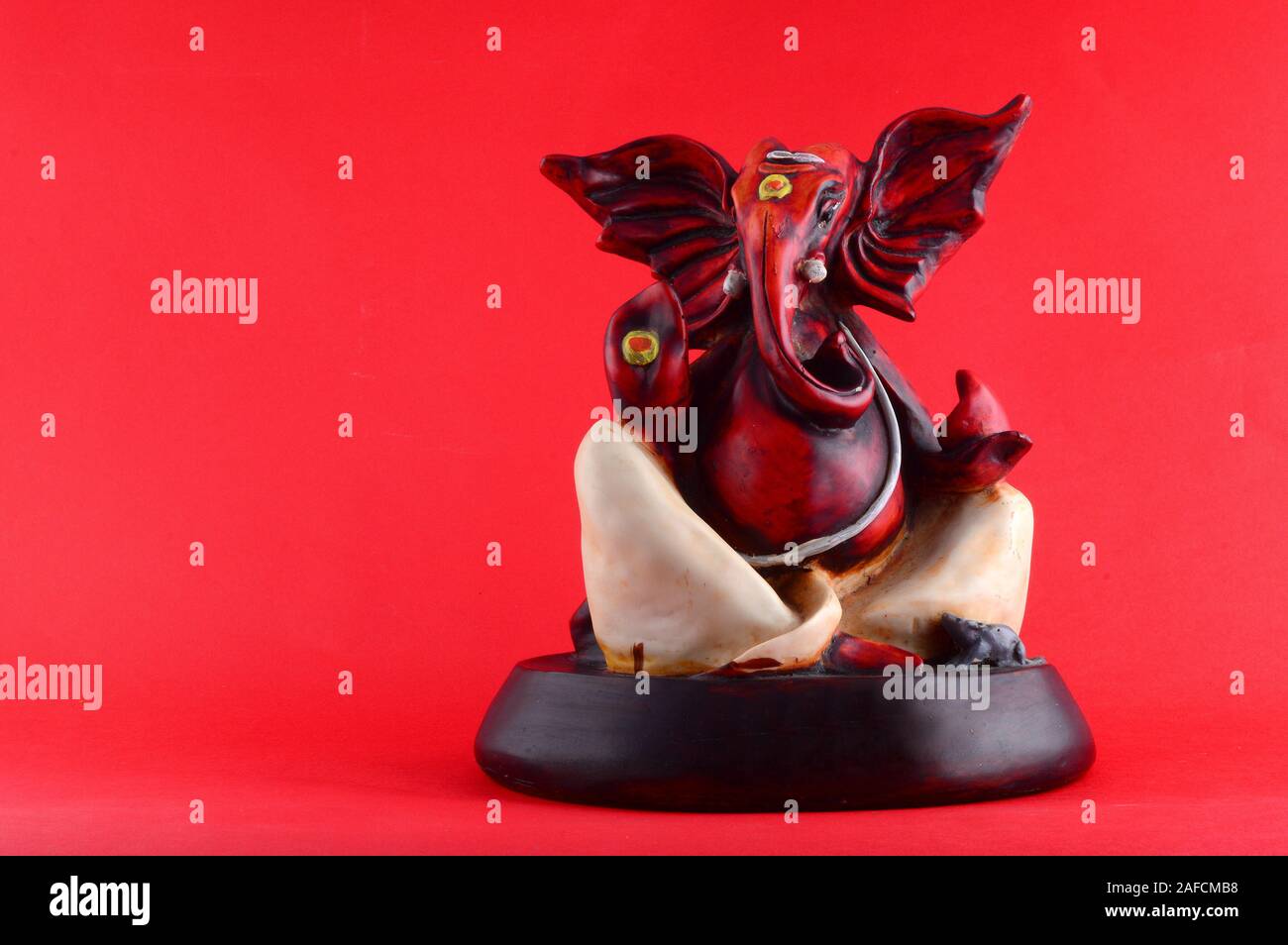 Hindu God Ganesha. Ganesha Idol on red Background Stock Photo - Alamy