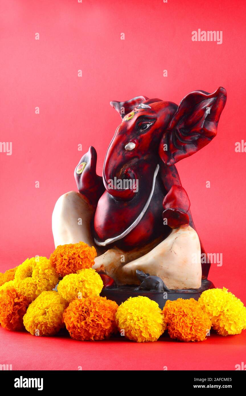 Hindu God Ganesha. Ganesha Idol on red Background Stock Photo - Alamy