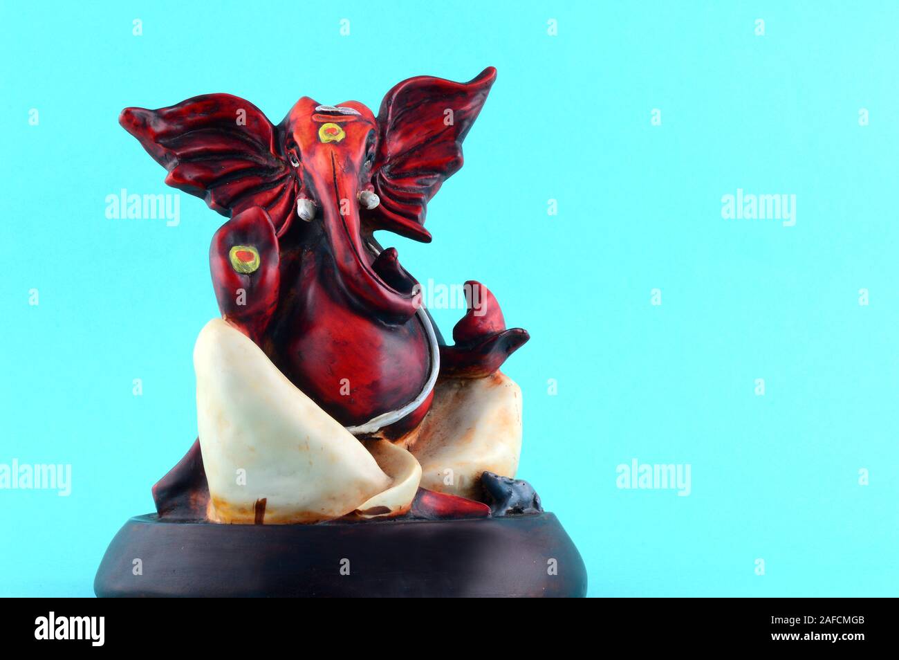 Hindu God Ganesha. Ganesha Idol on Blue Background Stock Photo - Alamy