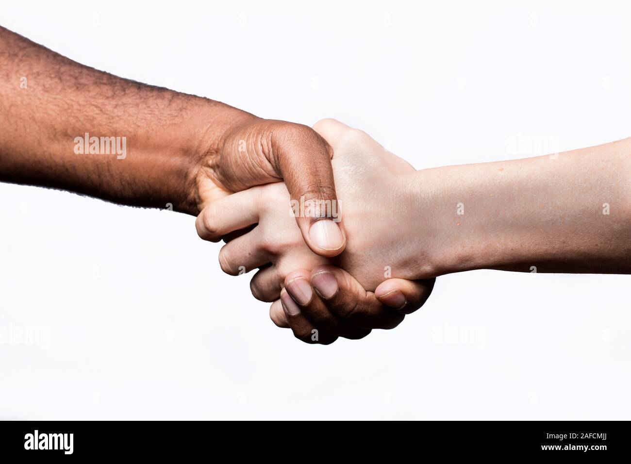 African man and Caucasian woman shake hands, studio shot, isolated ...