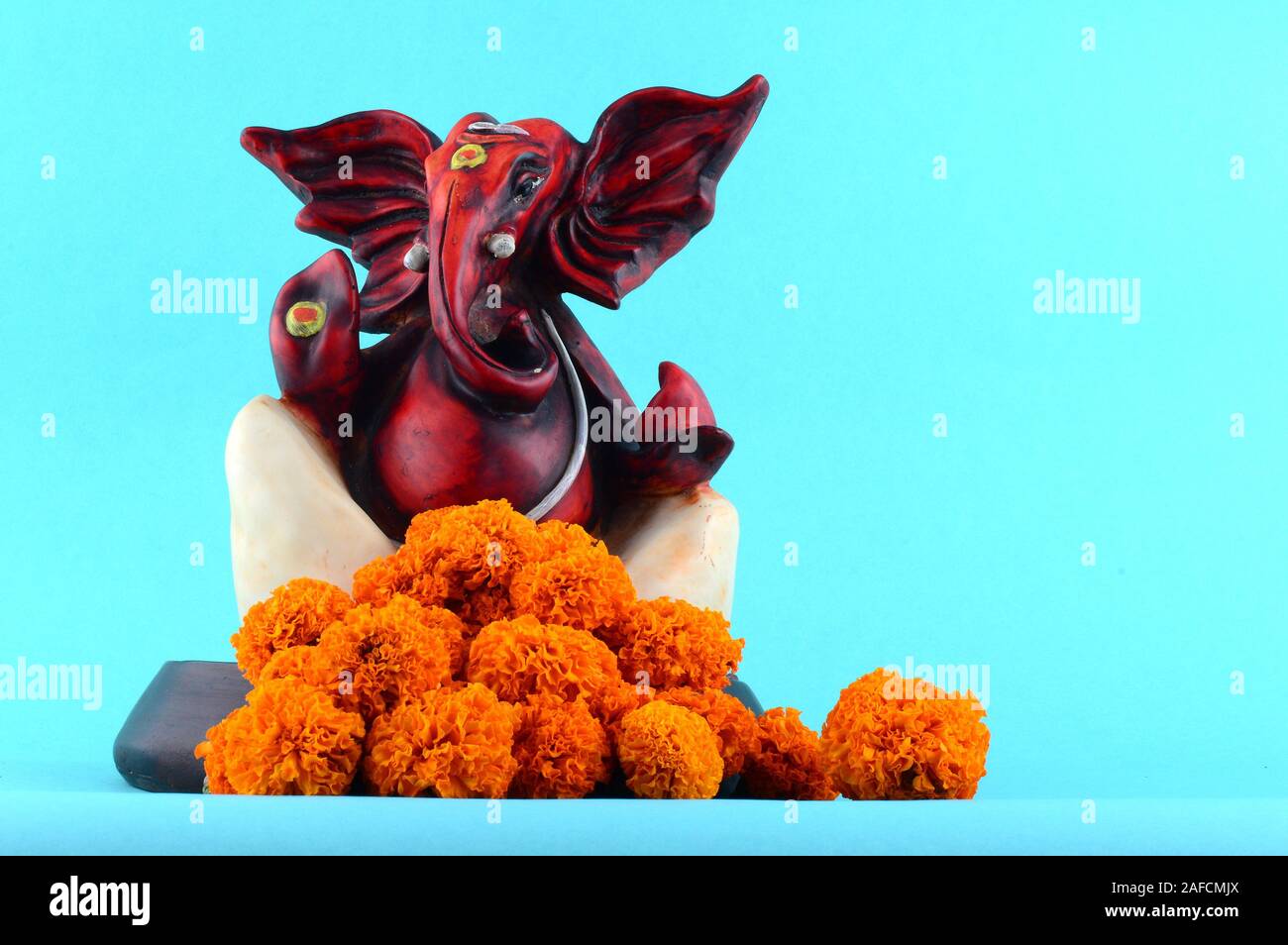 Hindu God Ganesha. Ganesha Idol on Blue Background Stock Photo - Alamy