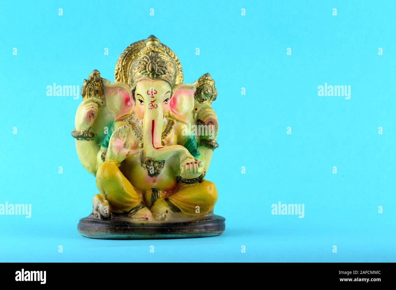 Hindu God Ganesha. Ganesha Idol on Blue Background Stock Photo - Alamy