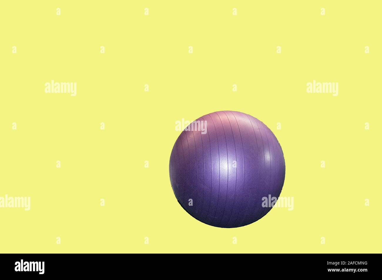 Large purple fitness ball isolated on yellow background by clipping ...