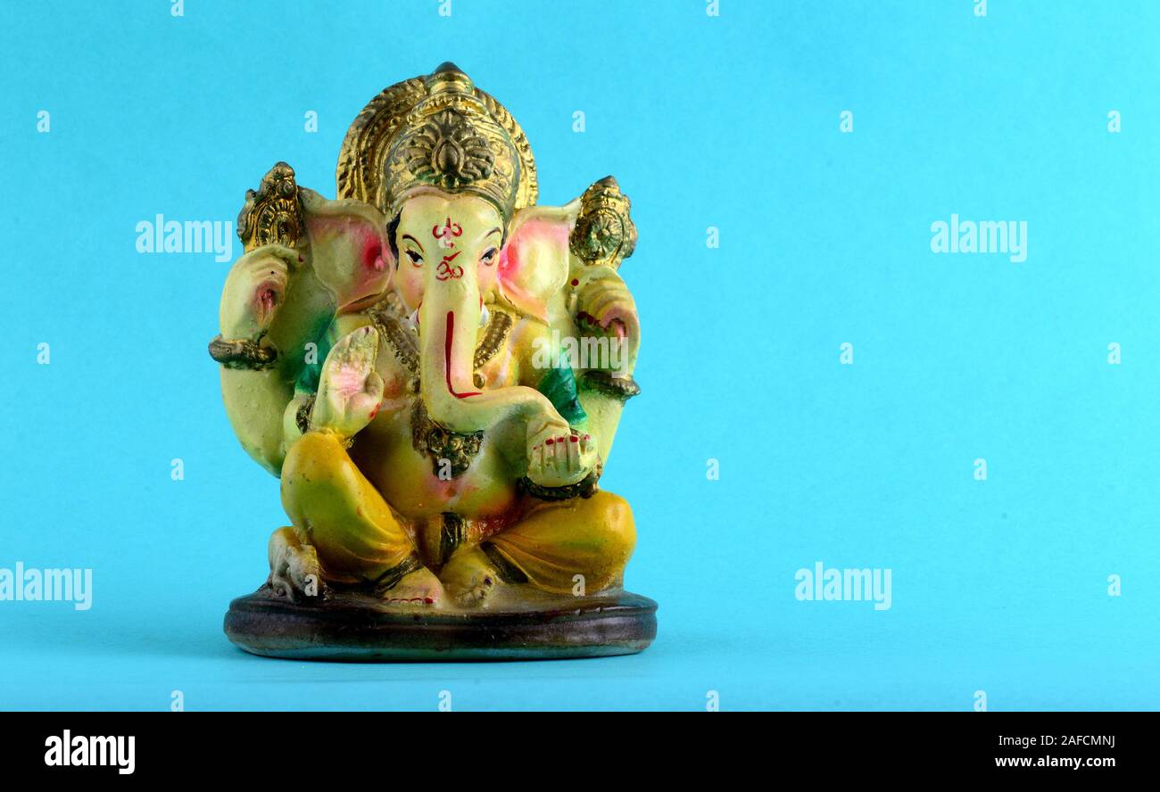 Hindu God Ganesha. Ganesha Idol on Blue Background Stock Photo - Alamy