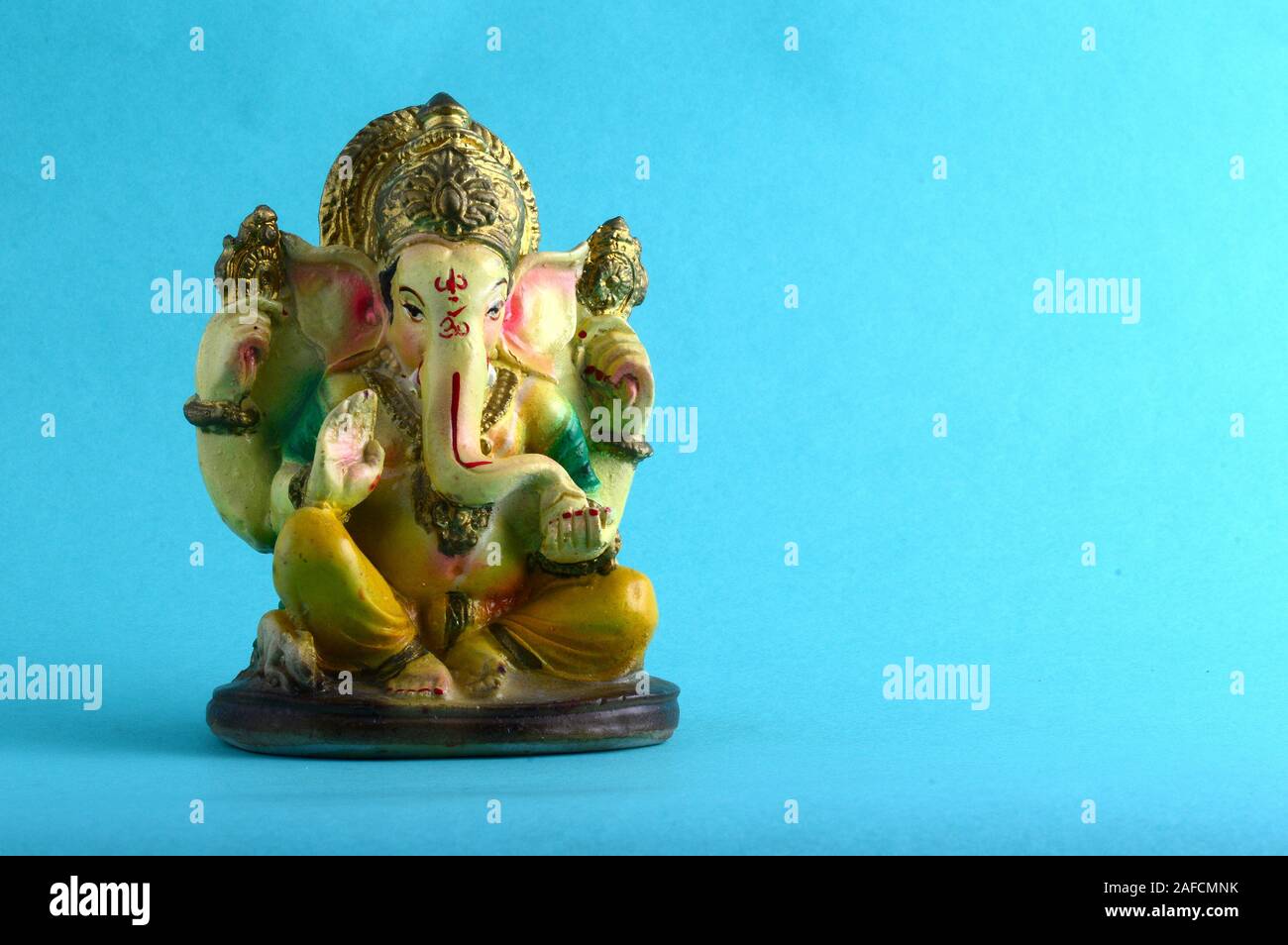 Hindu God Ganesha. Ganesha Idol on Blue Background Stock Photo - Alamy