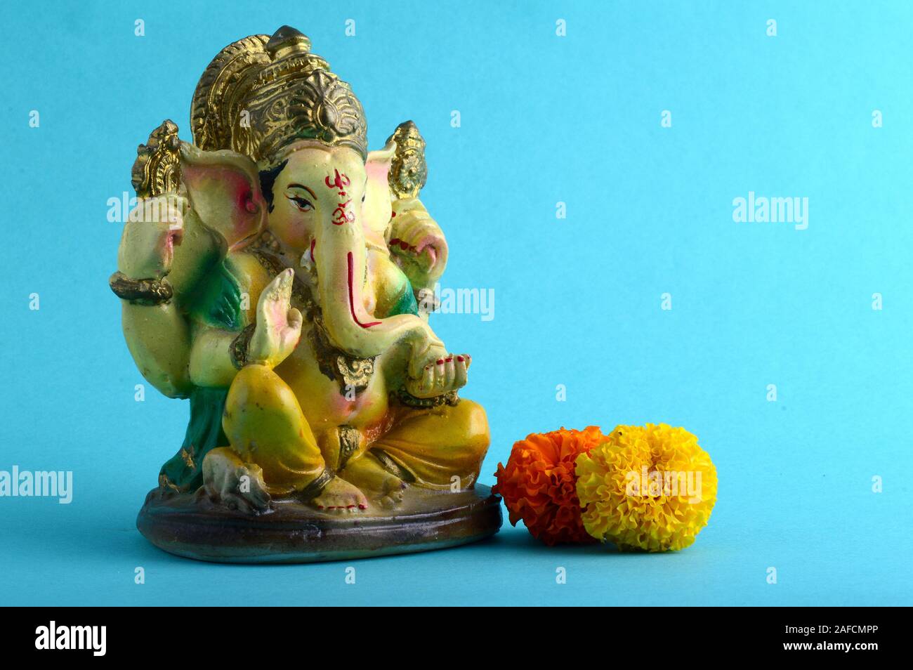 Hindu God Ganesha. Ganesha Idol on Blue Background Stock Photo - Alamy