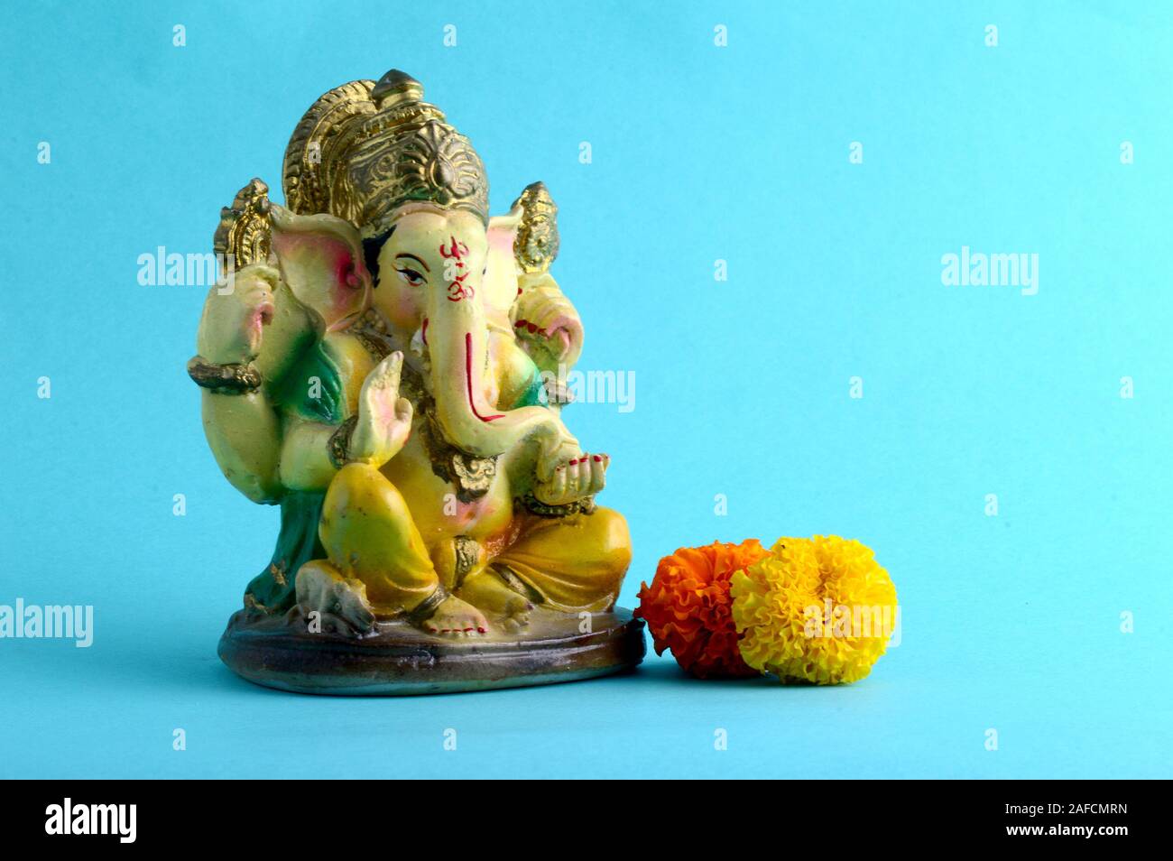 Hindu God Ganesha. Ganesha Idol on Blue Background Stock Photo - Alamy