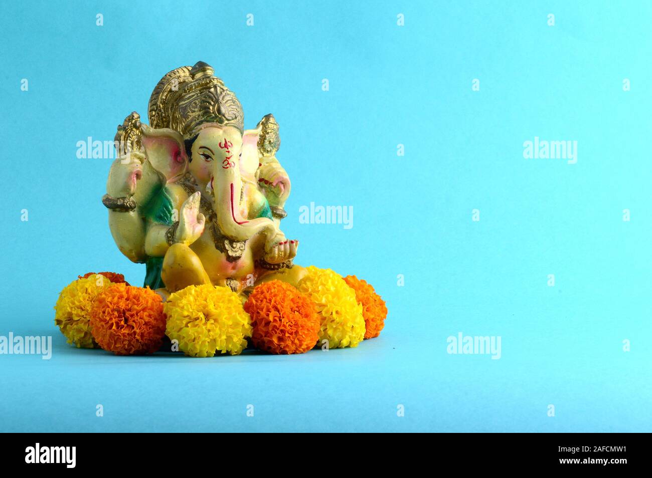 Hindu God Ganesha. Ganesha Idol on Blue Background Stock Photo - Alamy