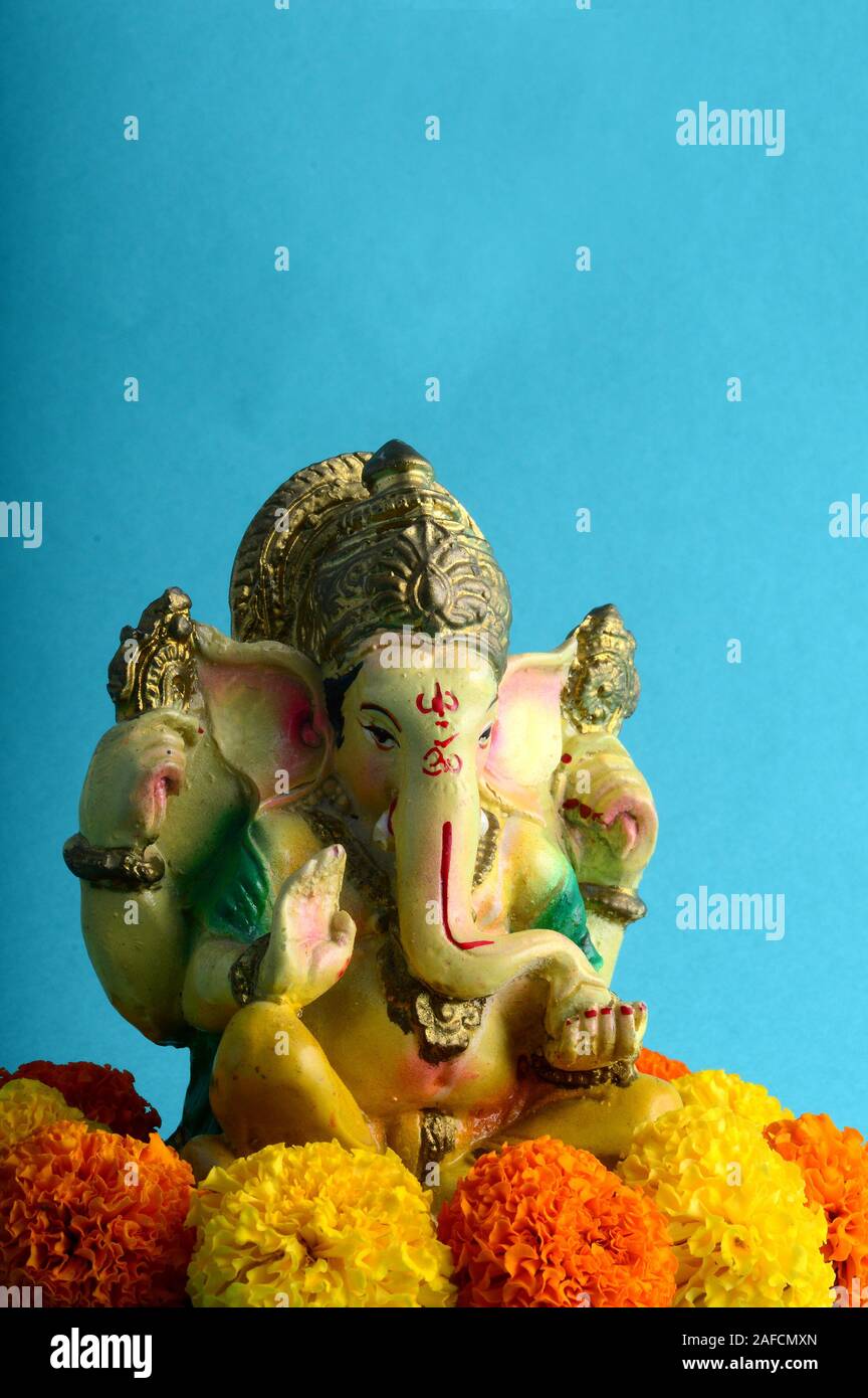 Hindu God Ganesha. Ganesha Idol on Blue Background Stock Photo - Alamy