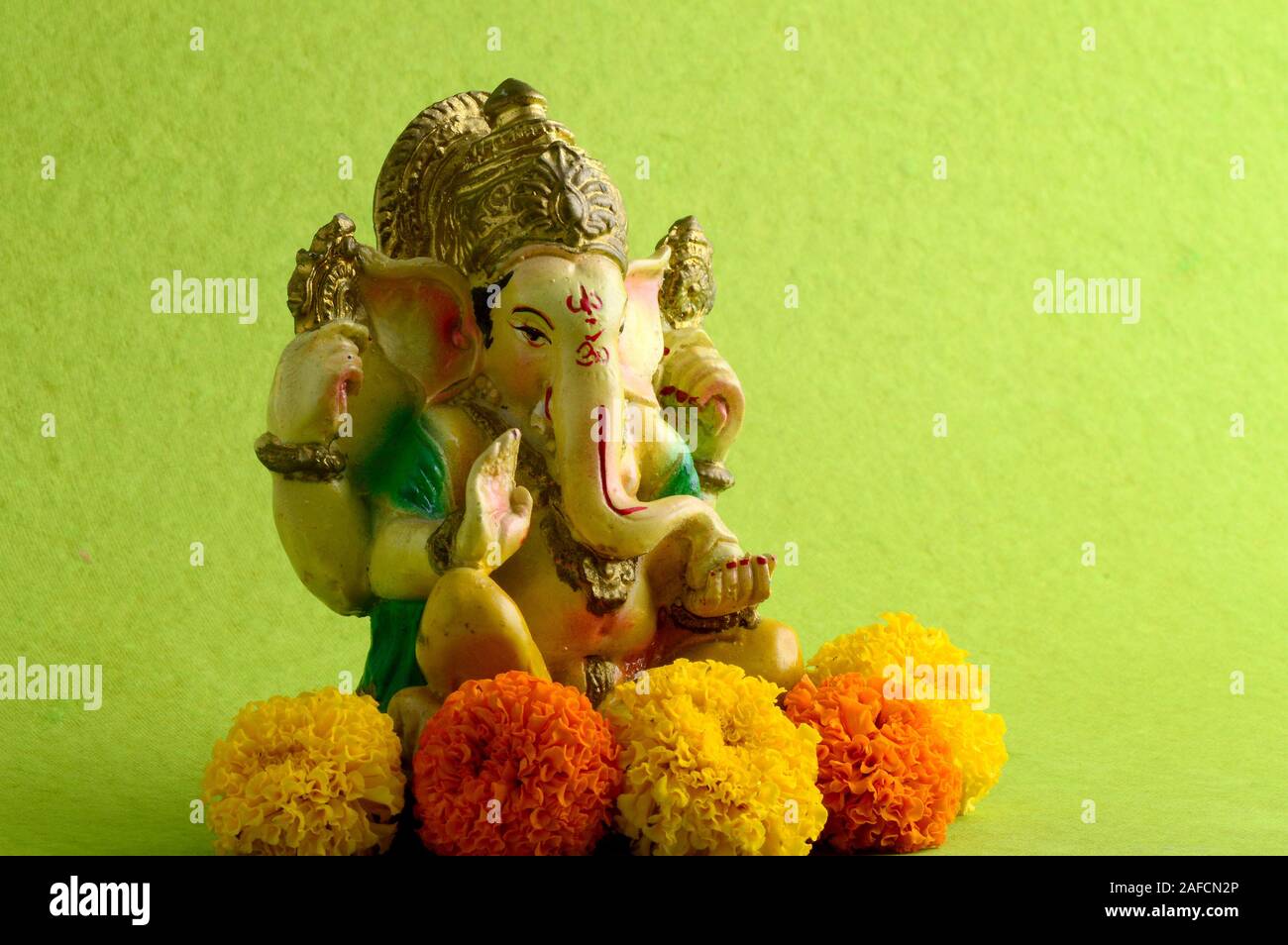 Hindu God Ganesha. Ganesha Idol on Green Background Stock Photo - Alamy