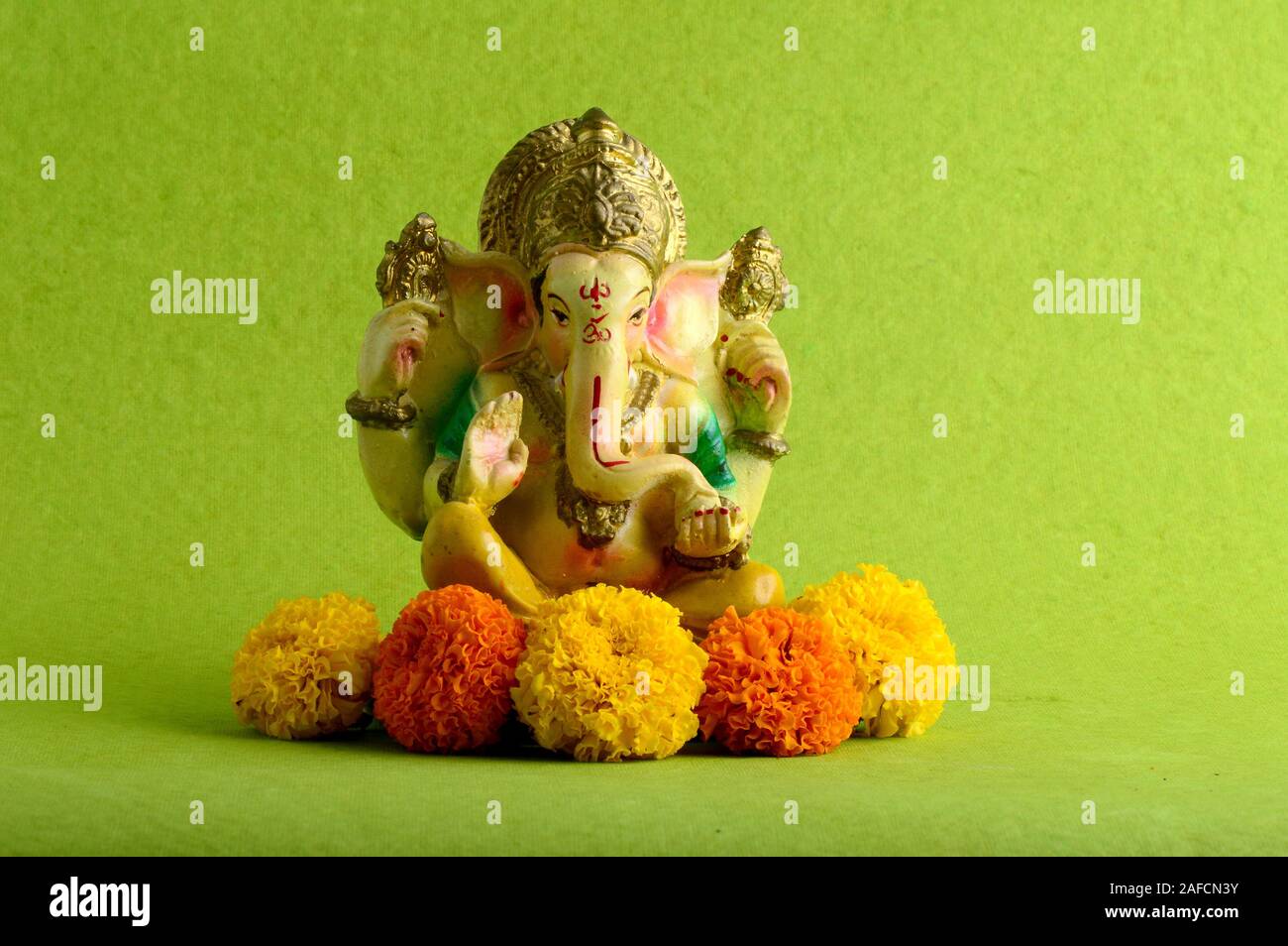 Hindu God Ganesha. Ganesha Idol on Green Background Stock Photo - Alamy