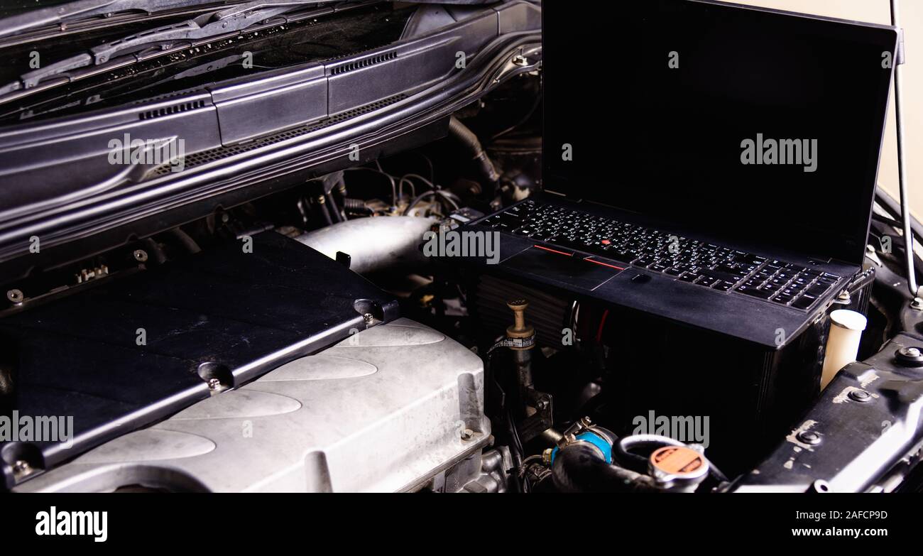 Laptop computer on car mechanic engine for service at workshop Stock ...