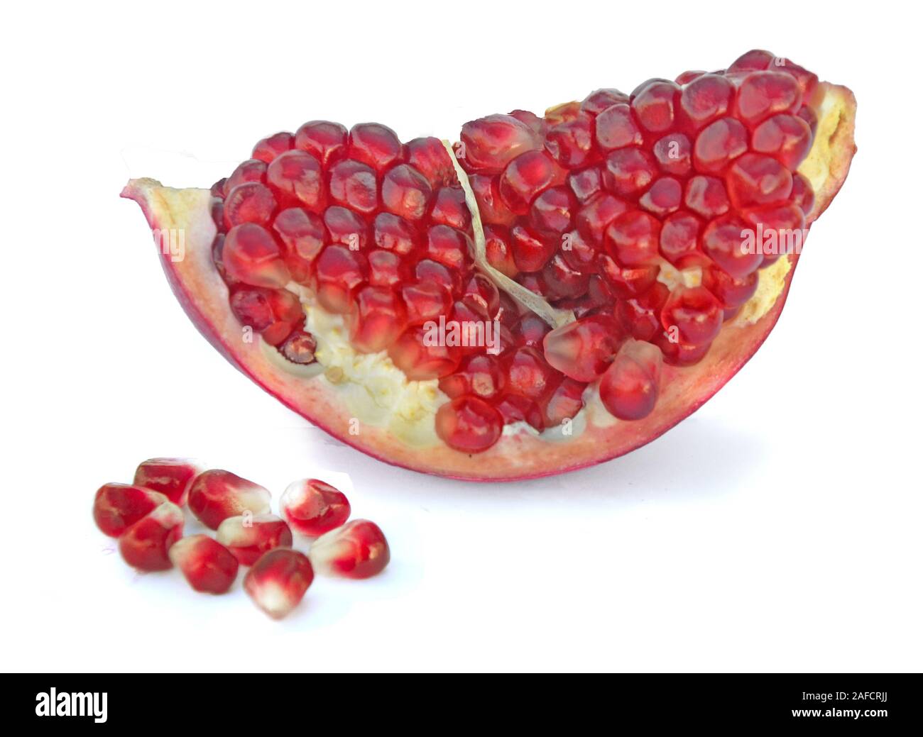 Open pomegranate and arils isolated on white background Stock Photo - Alamy