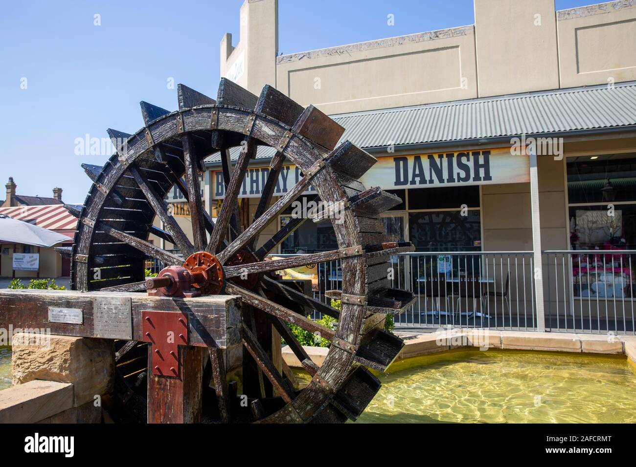 Windsor town centre in New South Wales and traditional water wheel ...