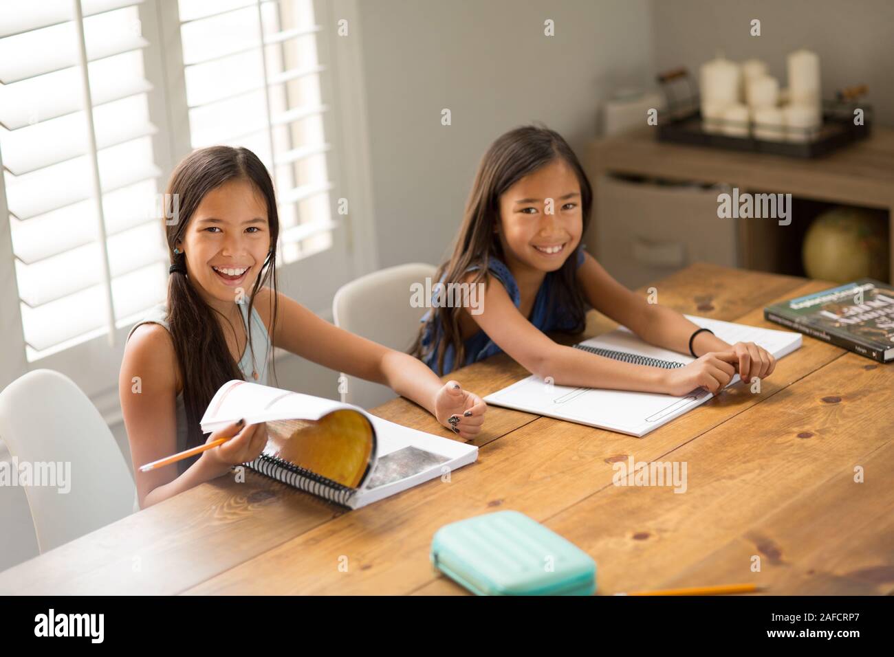 Young Girls Working On Their School Work Stock Photo - Alamy