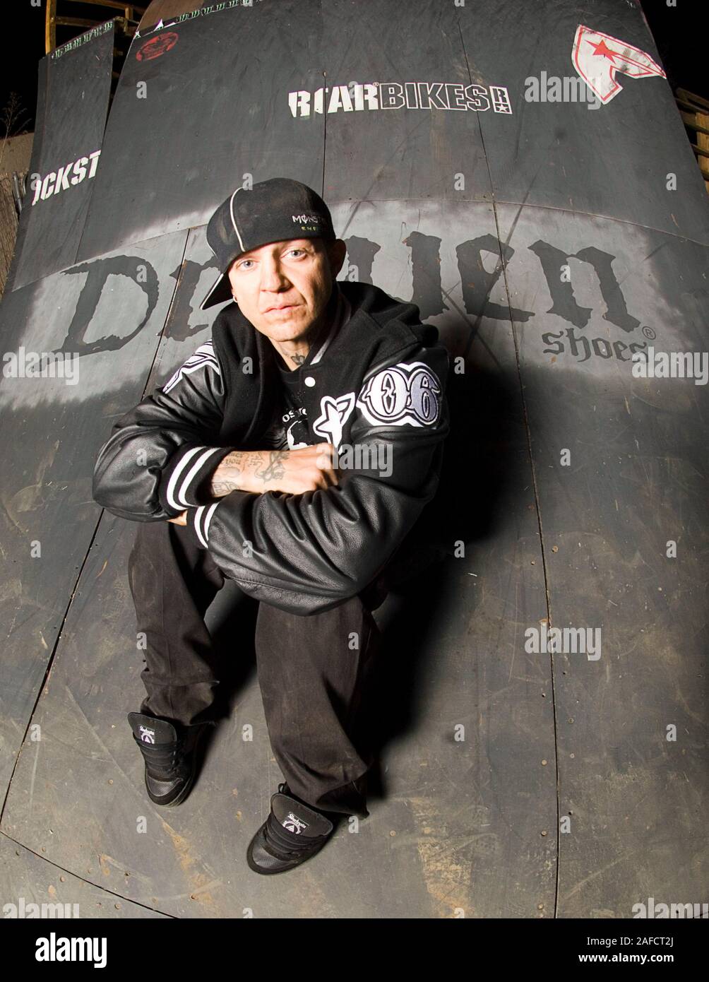 BMX pro rider Rick Thorne portrait at his house working on his custom ...