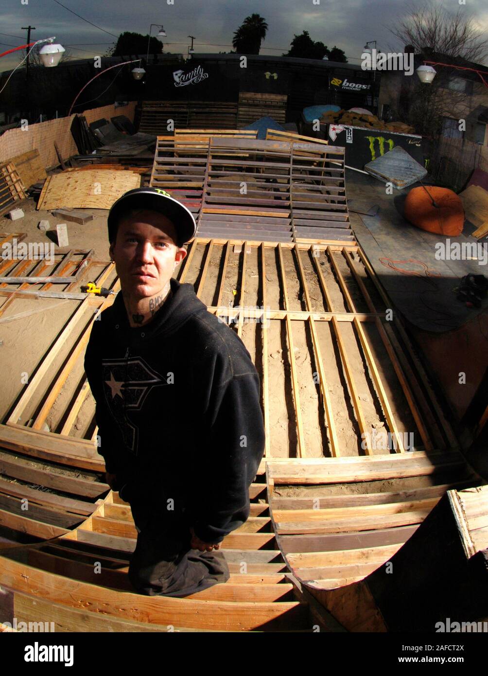 BMX pro rider Rick Thorne portrait at his house working on his custom ...