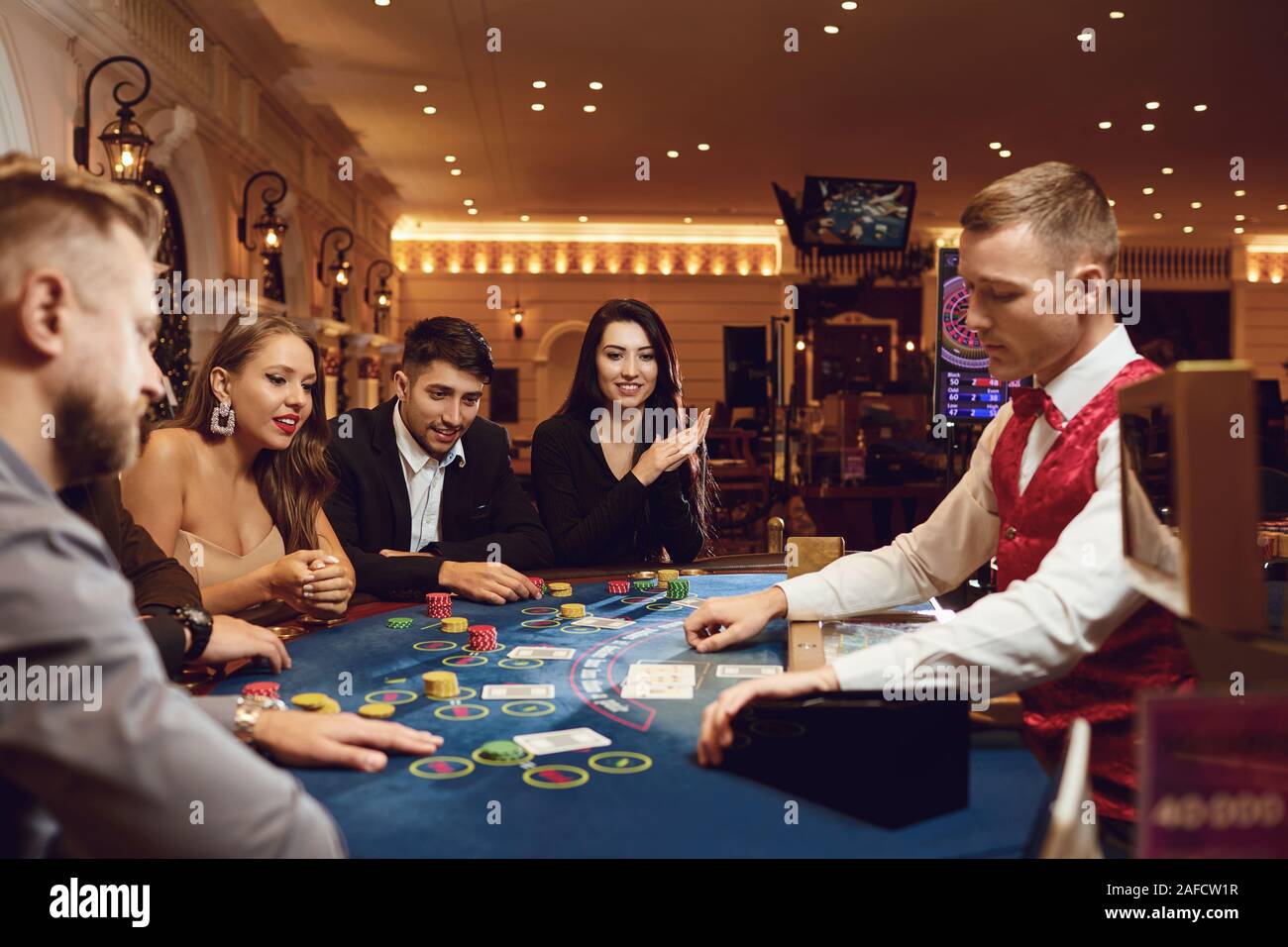 People gamble at a poker table in a casino Stock Photo - Alamy
