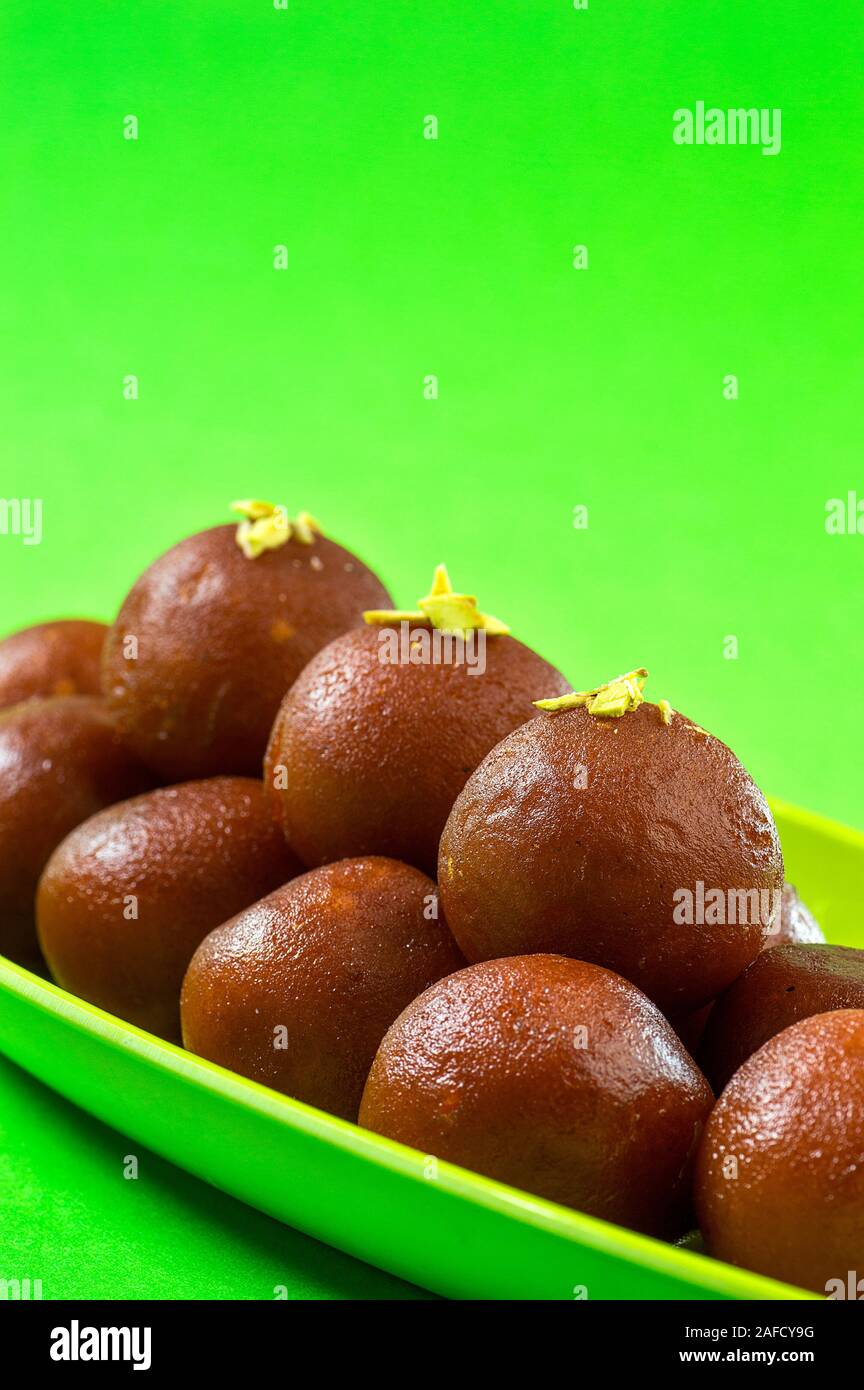 Gulab Jamun in plate on green background. Indian Dessert or Sweet Dish ...