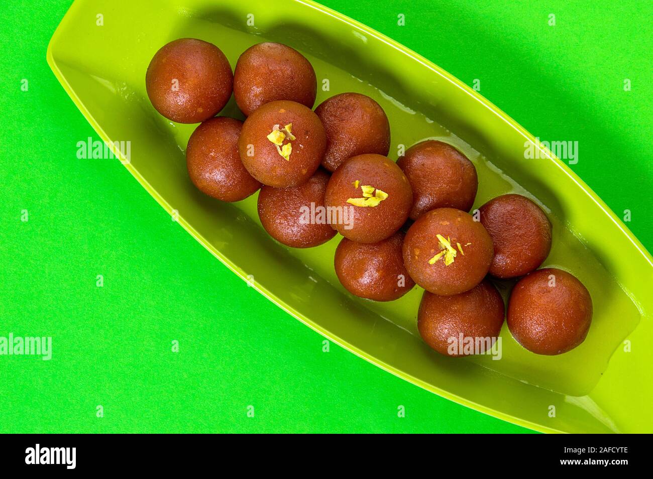 Gulab Jamun in plate on green background. Indian Dessert or Sweet Dish ...