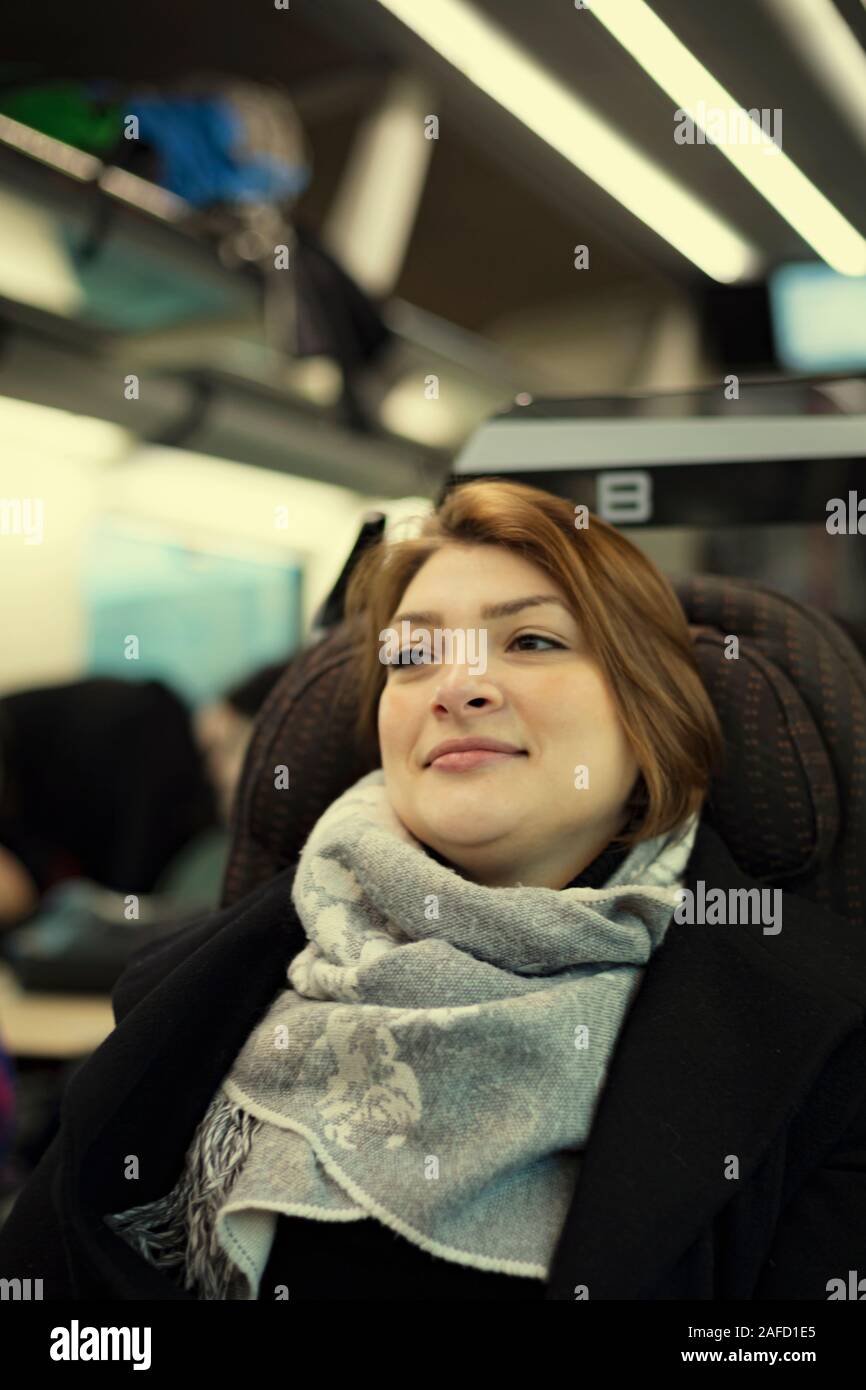 Beautiful young pensive woman as she goes in the train Stock Photo - Alamy
