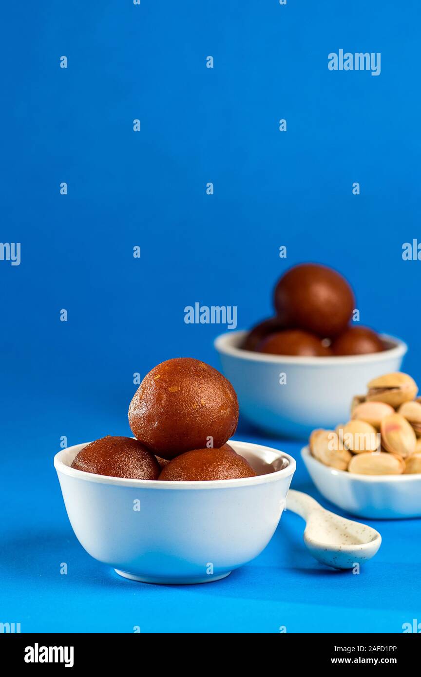 Indian Dessert : Gulab Jamun with Pistachio on blue background Stock ...