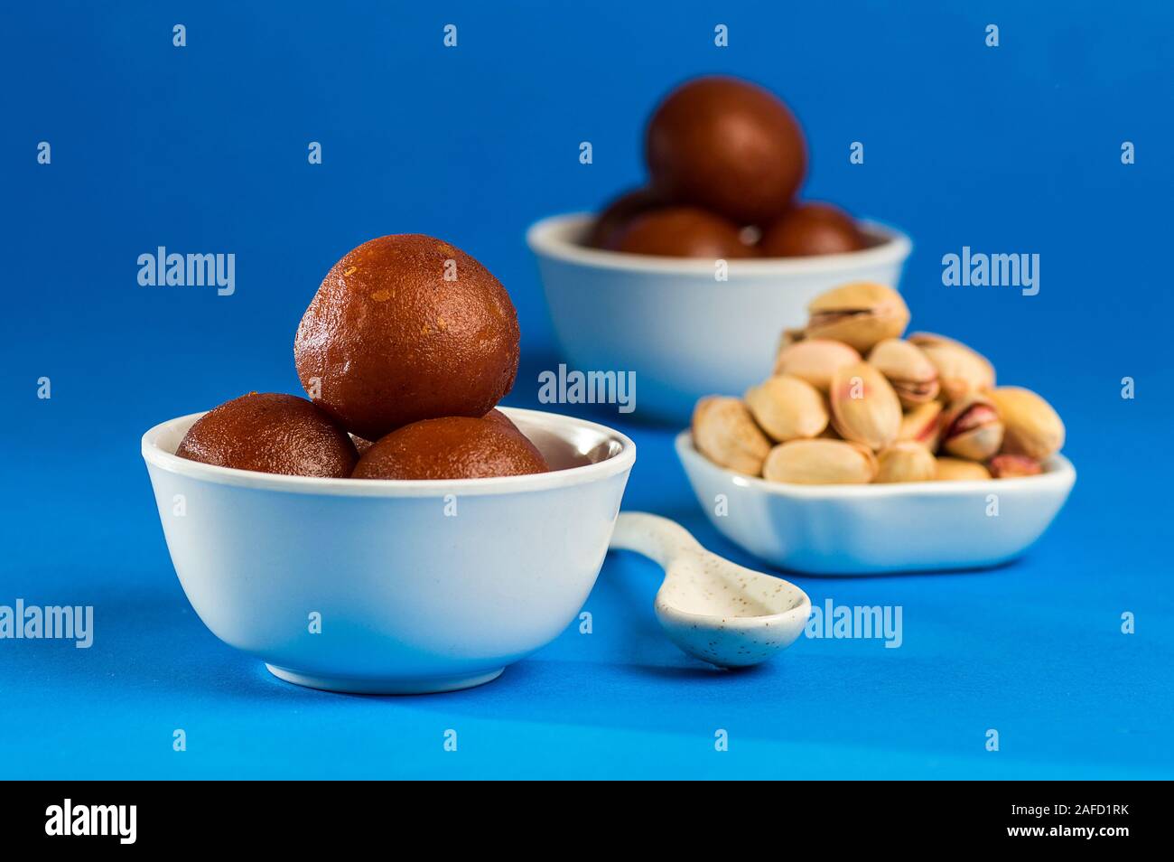 Indian Dessert : Gulab Jamun with Pistachio on blue background Stock ...