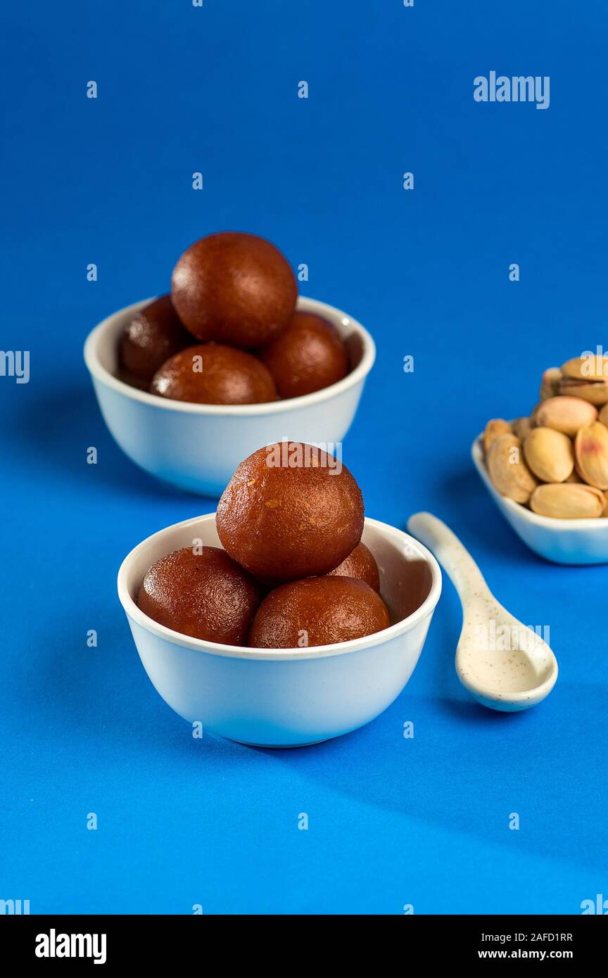 Indian Dessert : Gulab Jamun with Pistachio on blue background Stock ...