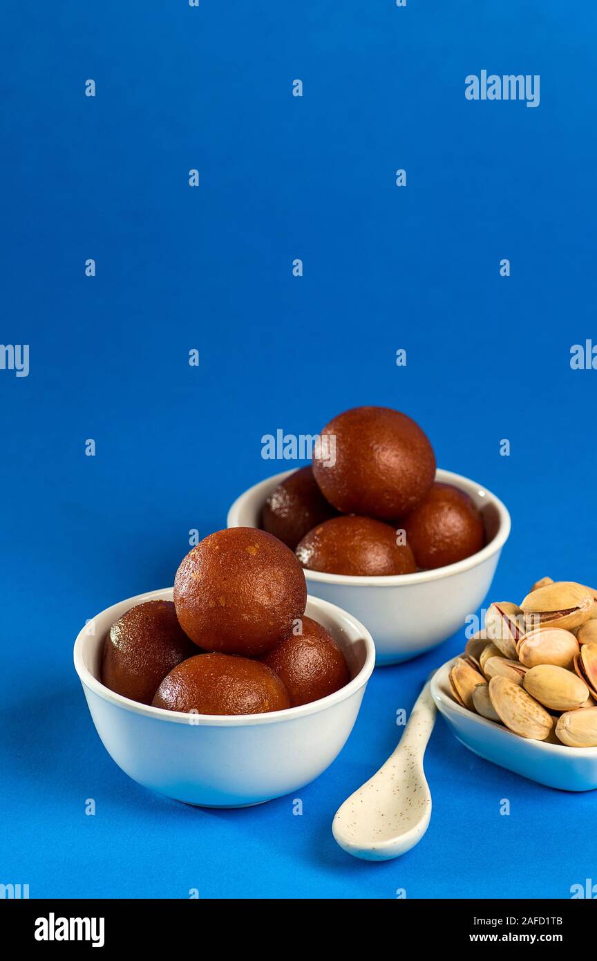 Indian Dessert : Gulab Jamun with Pistachio on blue background Stock ...