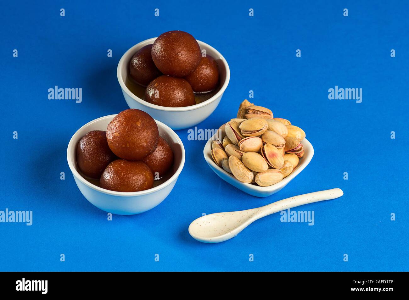 Indian Dessert : Gulab Jamun with Pistachio on blue background Stock ...