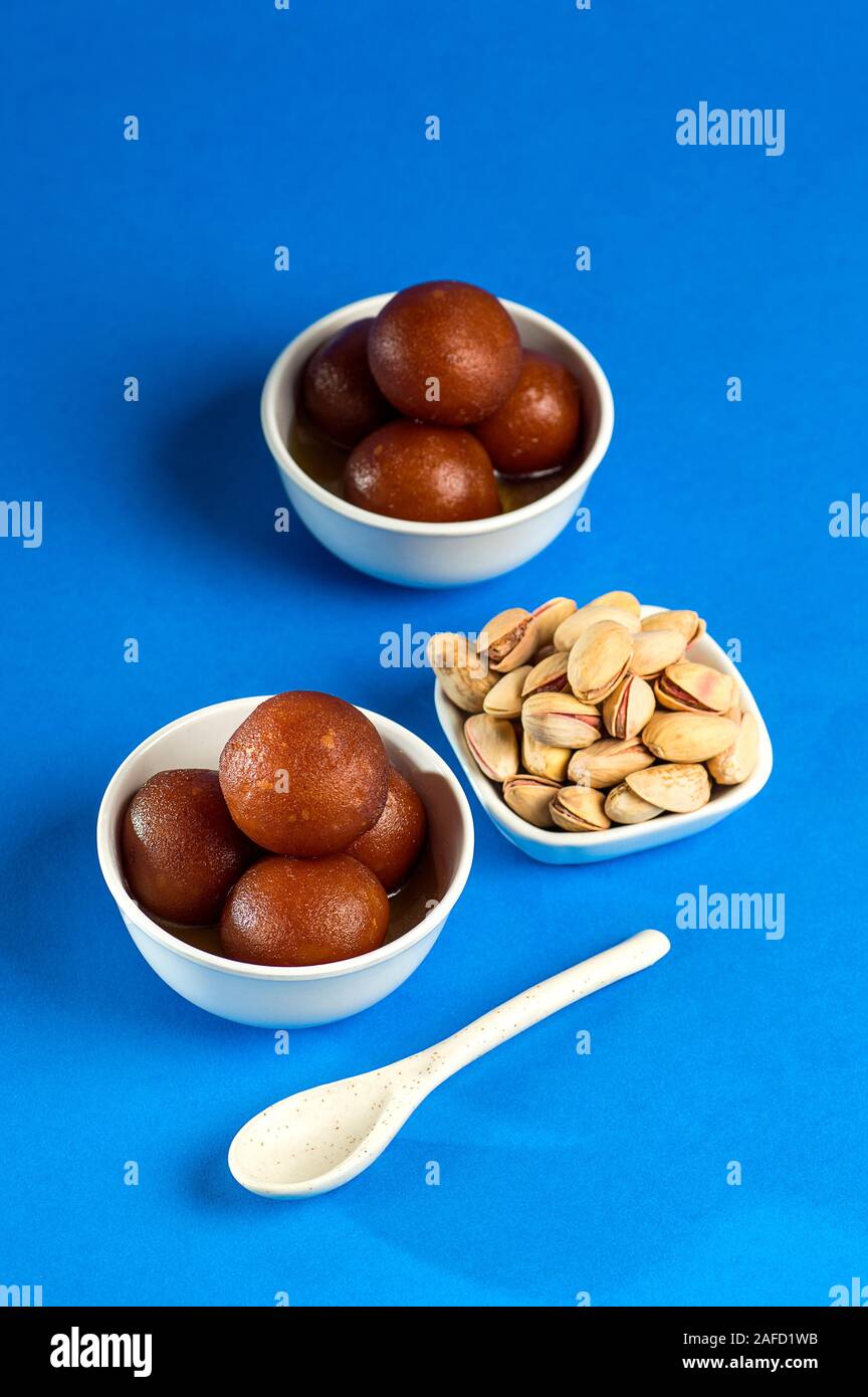 Indian Dessert : Gulab Jamun with Pistachio on blue background Stock ...