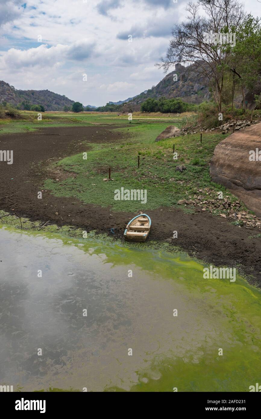 Matobo national Park, zimbabwe. A boat on the ground of an empty lake ...