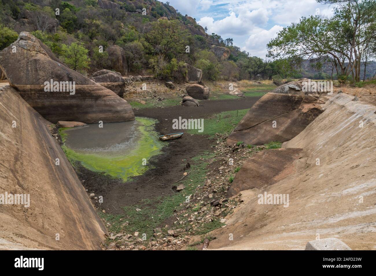 Matobo national Park, zimbabwe. A boat on the ground of an empty lake ...
