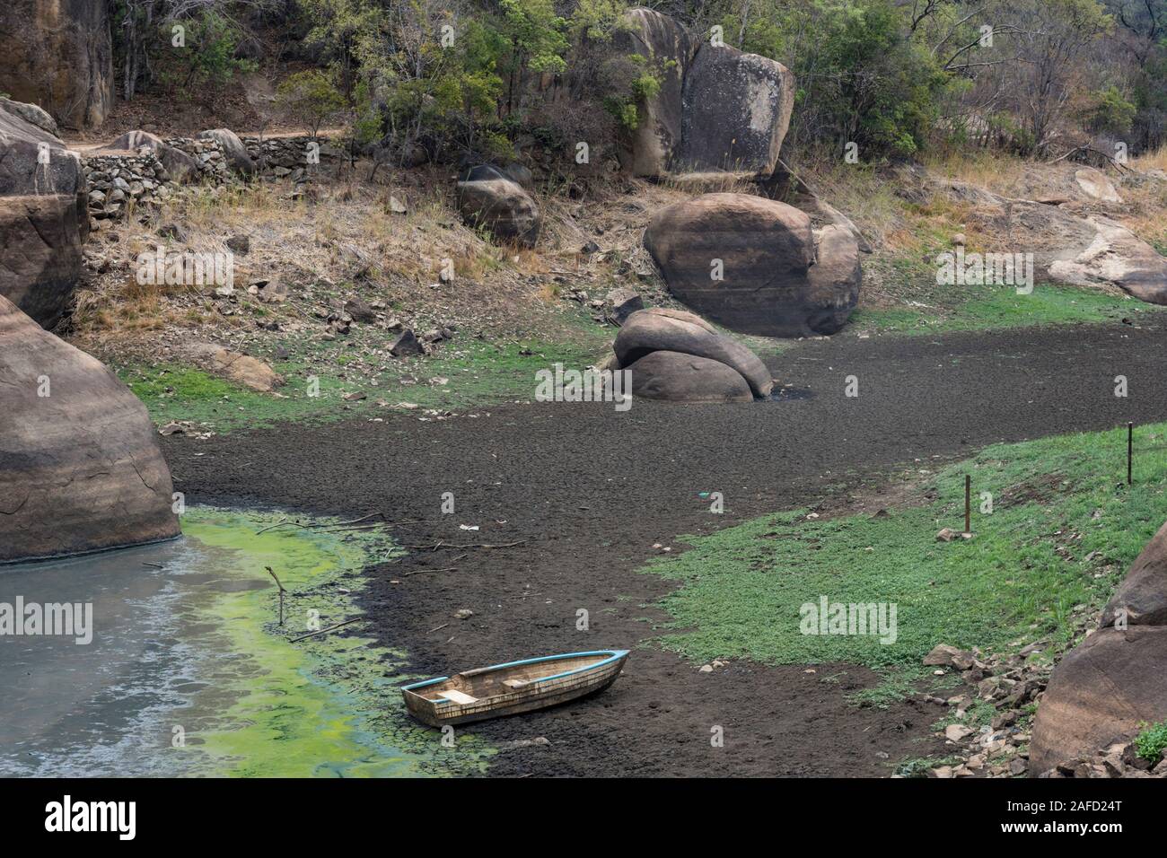 Matobo national Park, zimbabwe. A boat on the ground of an empty lake ...