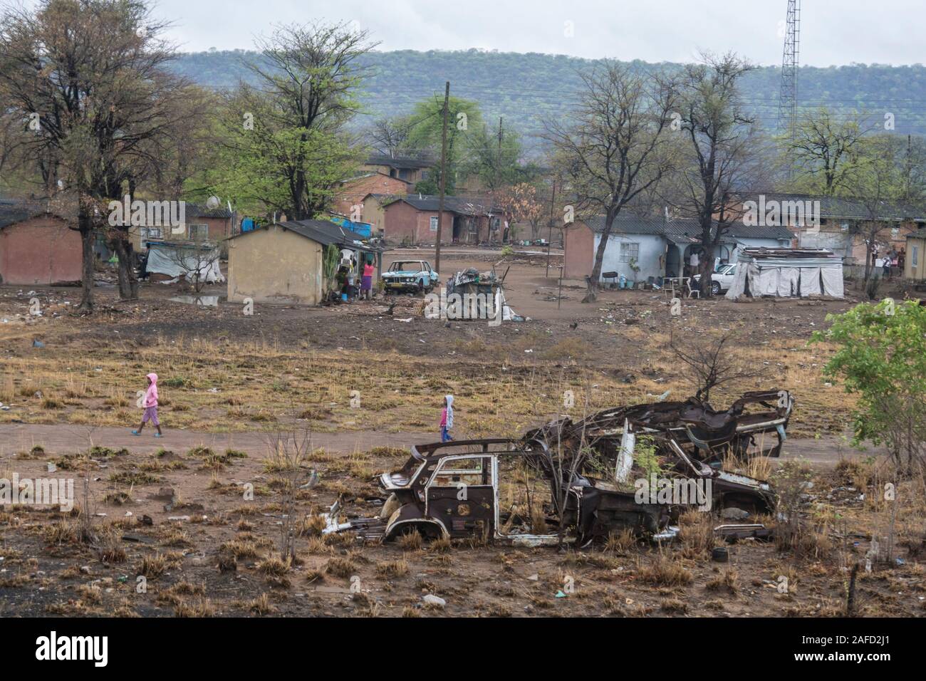 Zimbabwe. children walk on a dirt road in a poor village in ...
