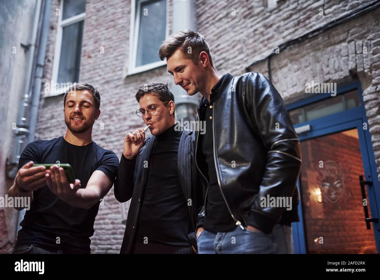 Group of three men stands hi-res stock photography and images - Alamy