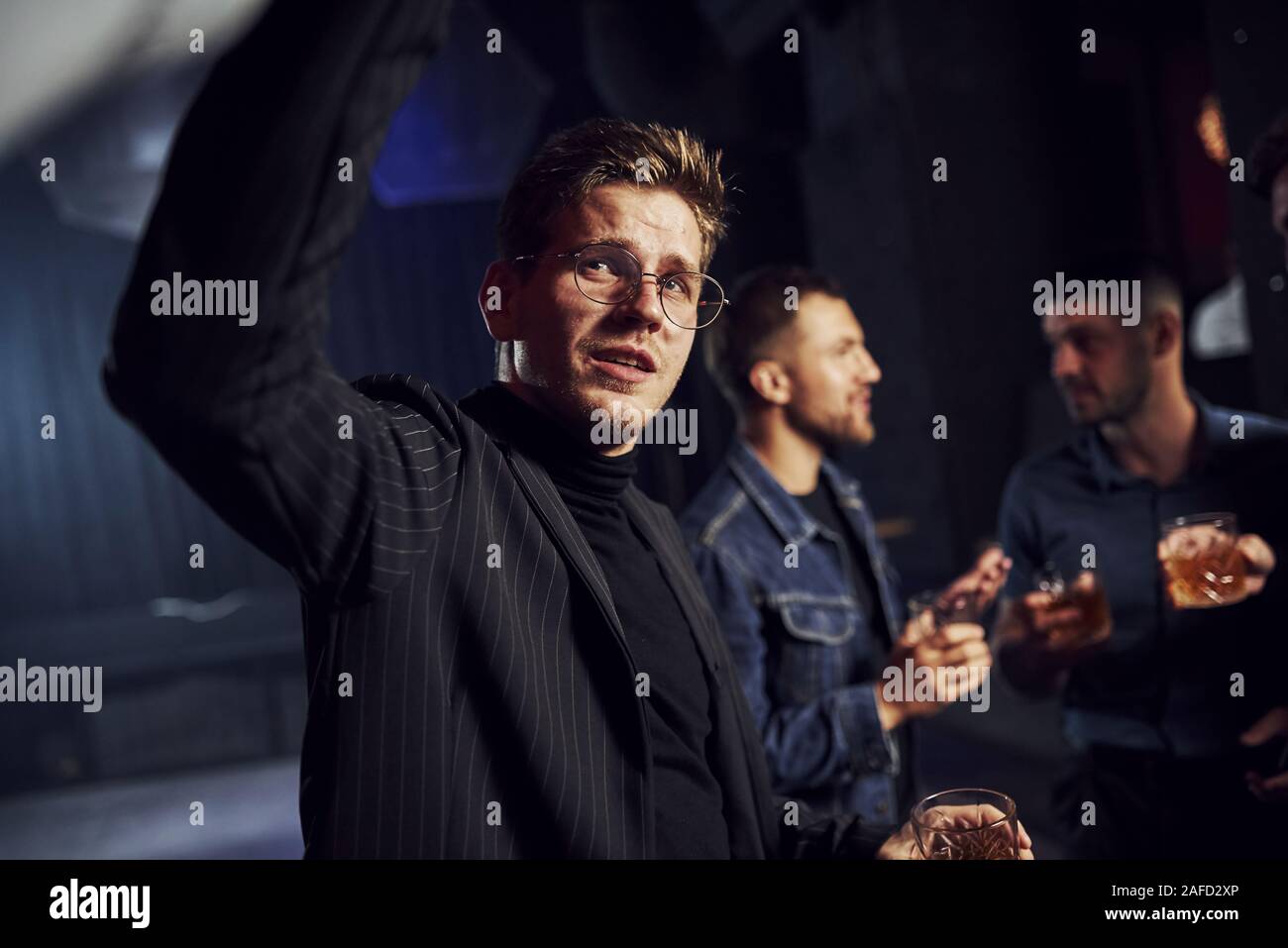 People have fun in the night club. With alcohol in hands Stock Photo ...