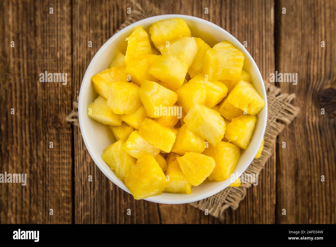 Fresh made Pineapple (sliced) on a vintage background as detailed close ...
