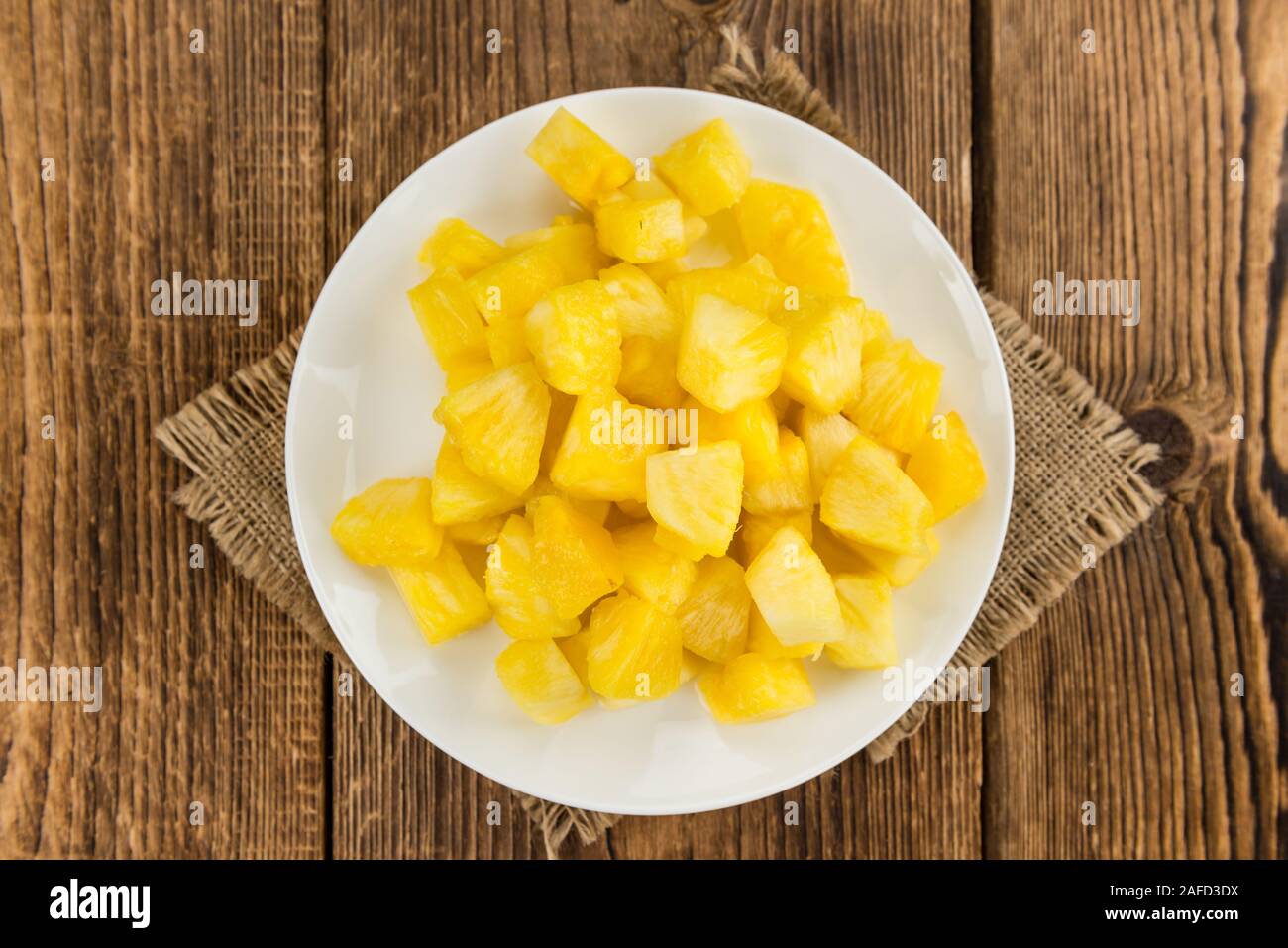 Fresh made Pineapple (sliced) on a vintage background as detailed close ...