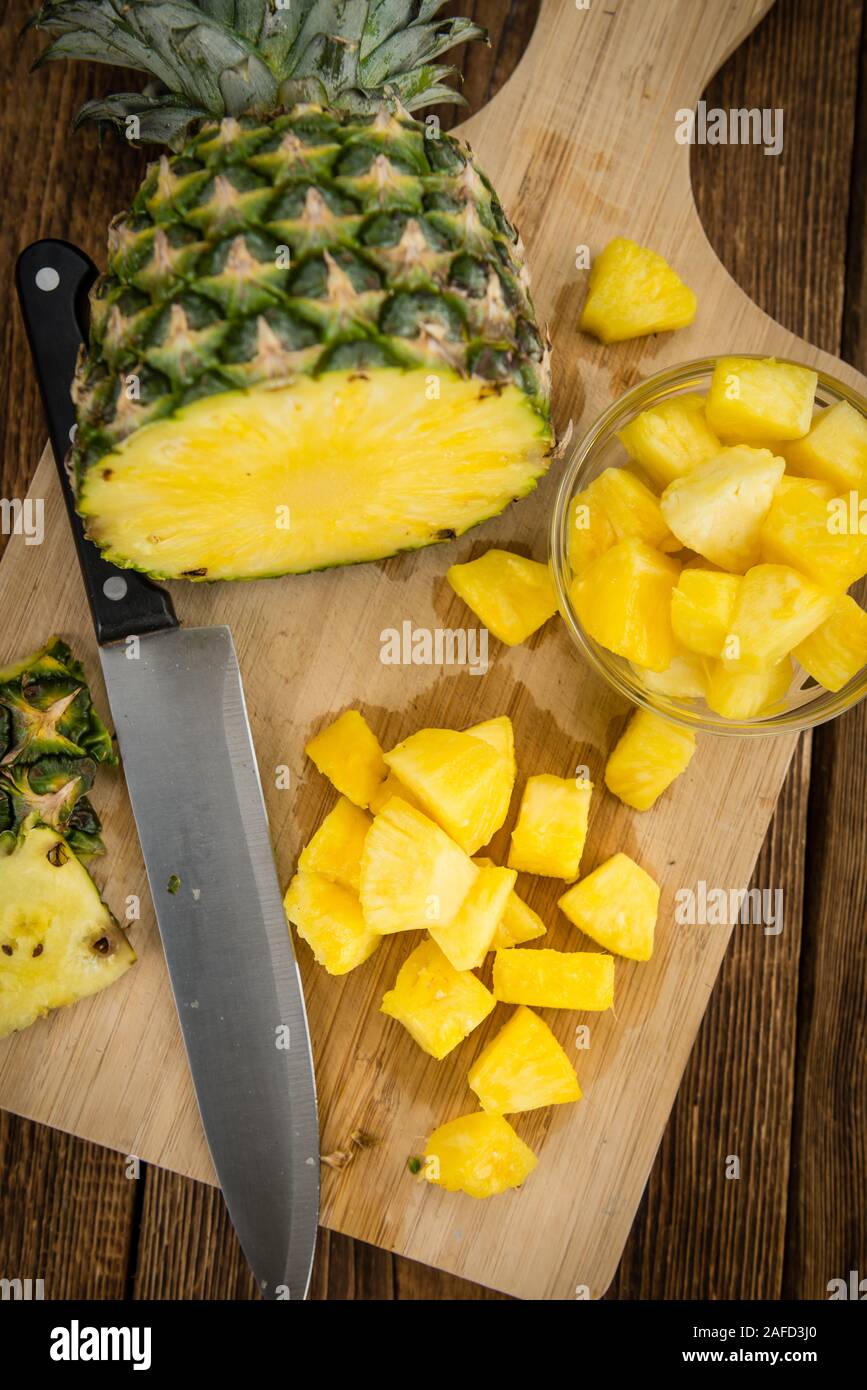 Fresh made Pineapple (sliced) on a vintage background as detailed close ...