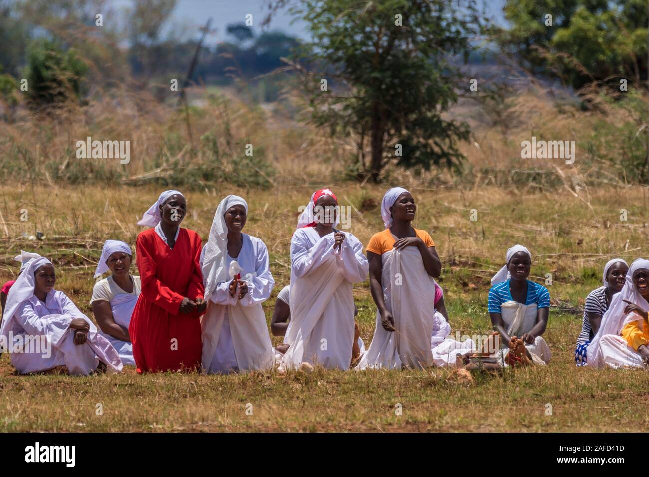 Zimbabwe. Women of the Vopostori (Masowe) apostolic church pray on a ...