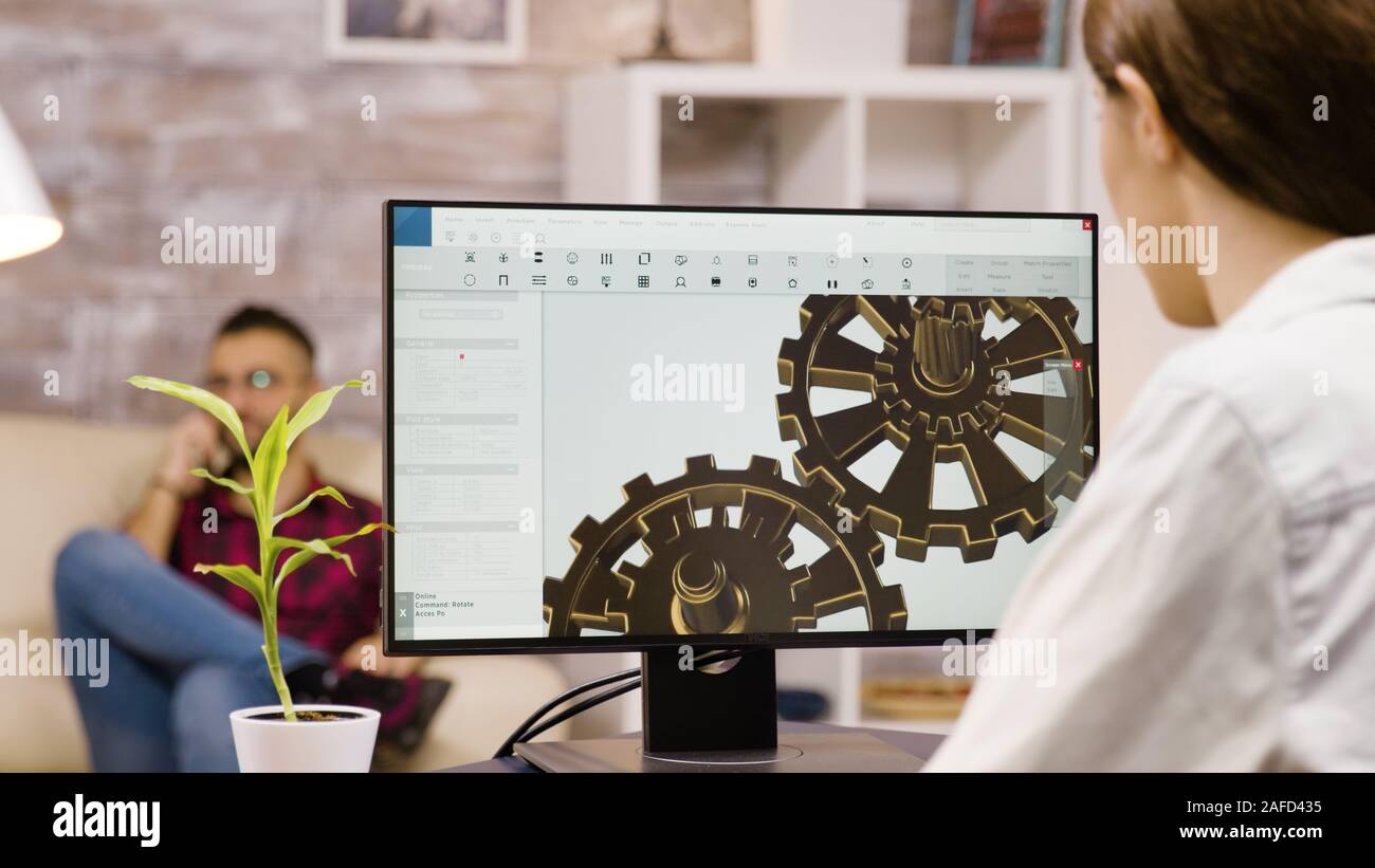 Back view of female engineer working on a mechanical concept from home ...