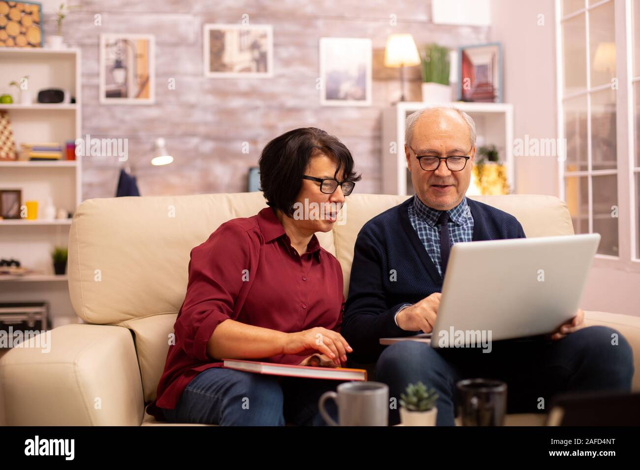Grandmother and grandfather using a laptop to chat with their grandsons ...