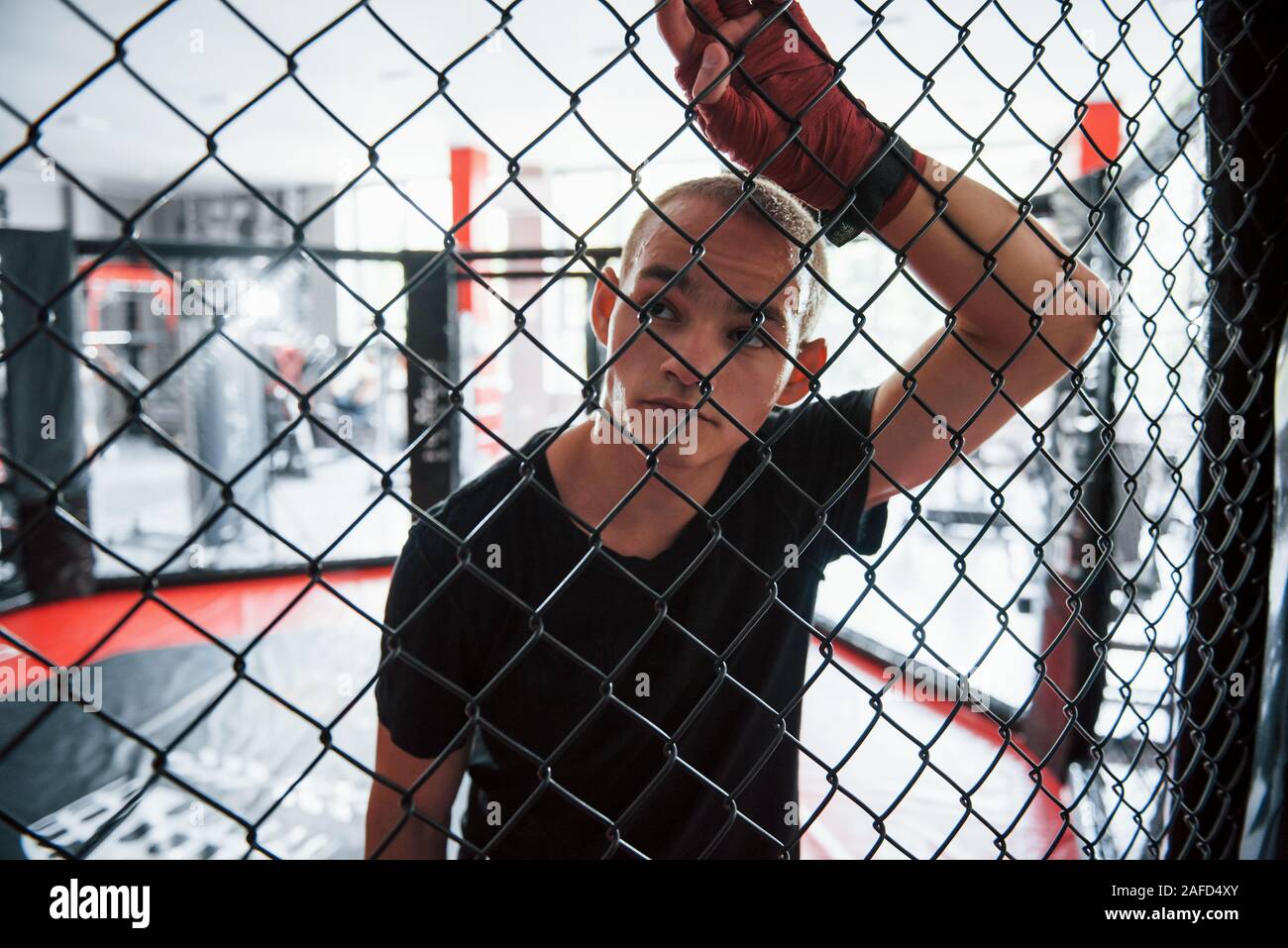 Taking a break. Sportsman at boxing ring have exercise. Leaning on the ...